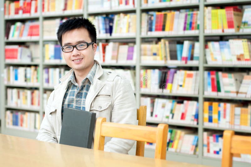 Handsome Man Sitting and Reading in Library Stock Image - Image of head ...