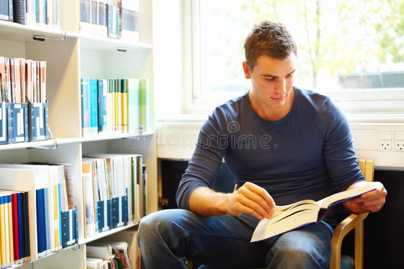 Handsome Man Sitting and Reading in Library Stock Photo - Image of high ...