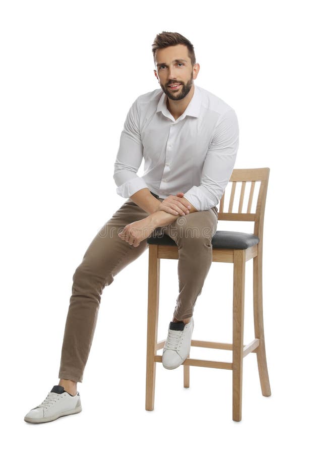 Handsome Man Sitting on Stool Against White Background Stock Image ...