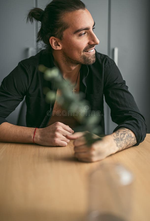 Handsome Man Sitting at Table Smiling in Natural Light Stock Image ...