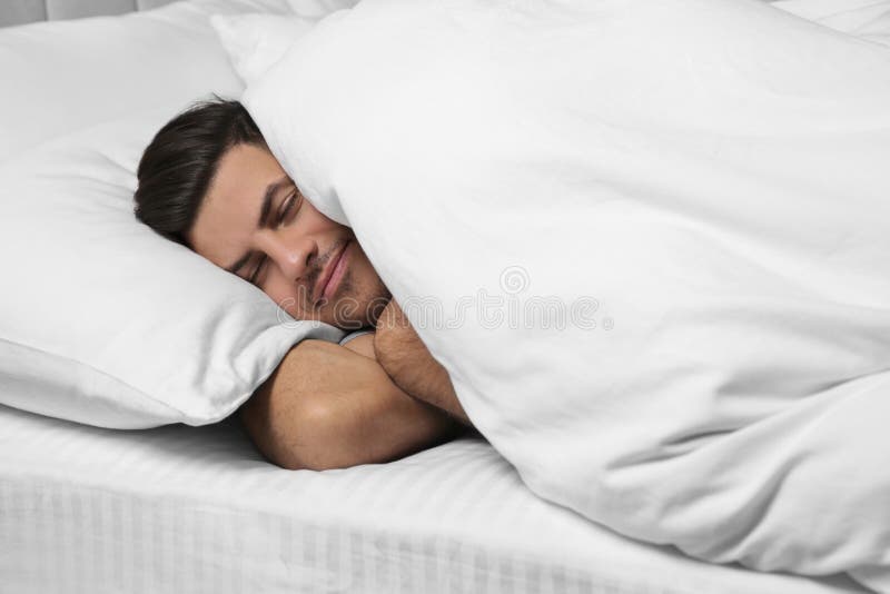 Handsome Man Sleeping Under Soft Blanket in Bed at Home Stock Photo ...