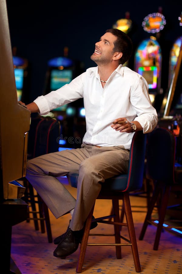 Handsome Man at the Slot Machine Stock Image - Image of betting, look ...