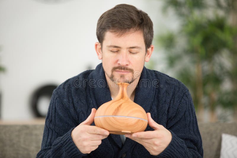 Handsome Man Smelling Aroma from Essential Oil Diffuser Stock Photo ...