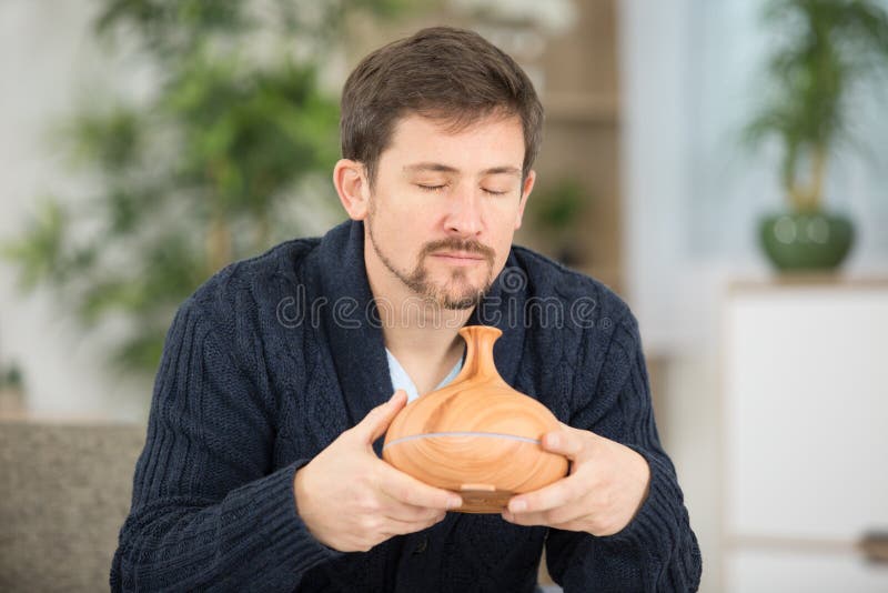 Handsome Man Smelling Aroma from Essential Oil Diffuser Stock Photo ...