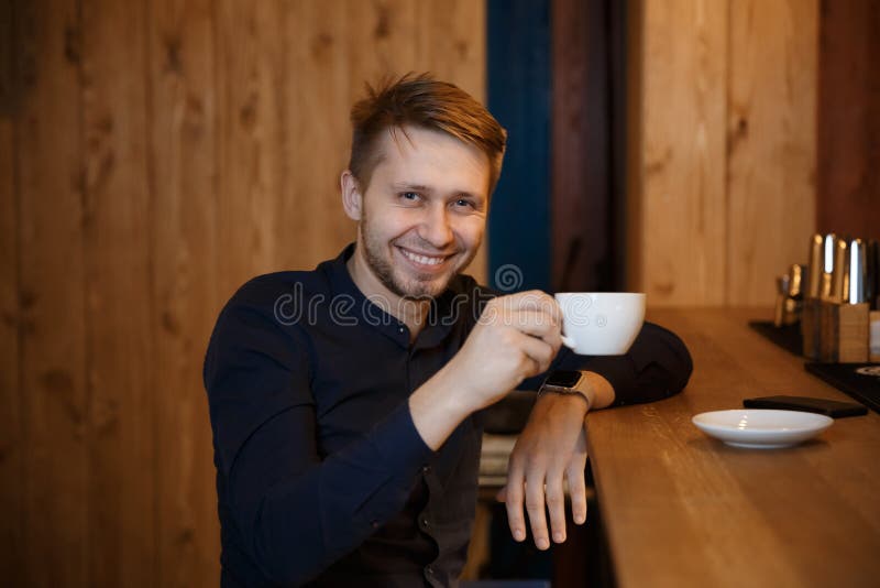Handsome Man Smiling with a Cup of Coffee in His Hand. Stock Image ...