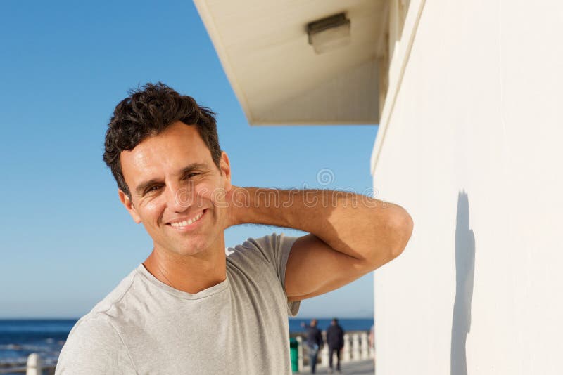 Handsome Man Smiling Outside with Hand in Hair Stock Photo - Image of ...
