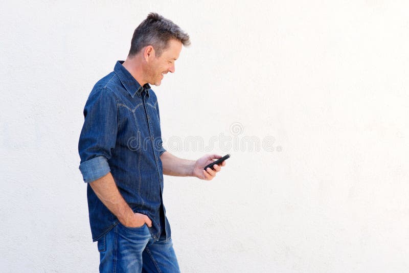 Handsome Man Smiling and Walking with Mobile Phone Stock Image - Image ...