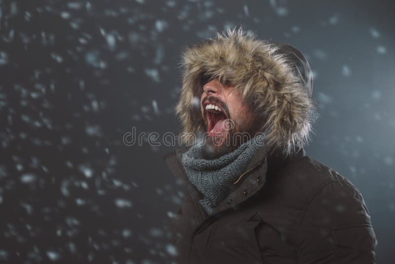 Handsome man in snow storm stock photo. Image of blue - 48744764