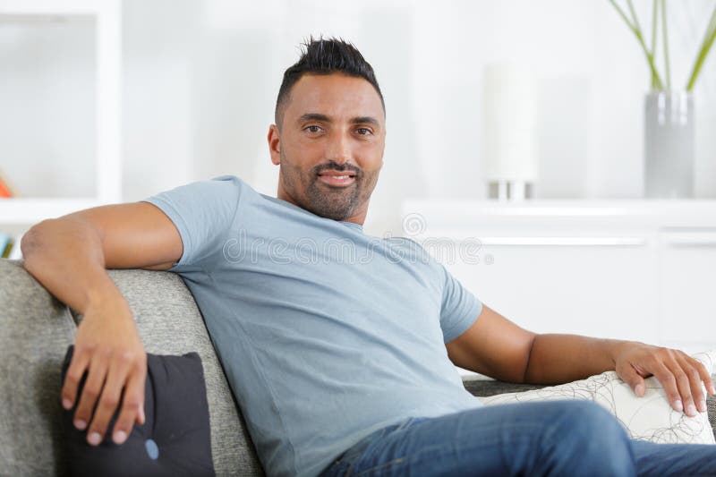 Handsome man on sofa stock image. Image of leisure, entertainment ...