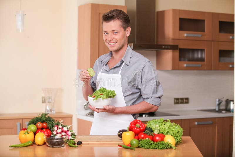 Handsome Man Squeezing Lime for Fresh Salad. Stock Photo - Image of ...