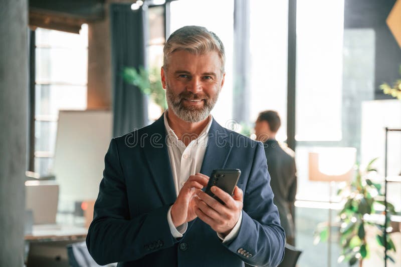 Handsome Man is Standing with Smartphone. Business People are Working ...