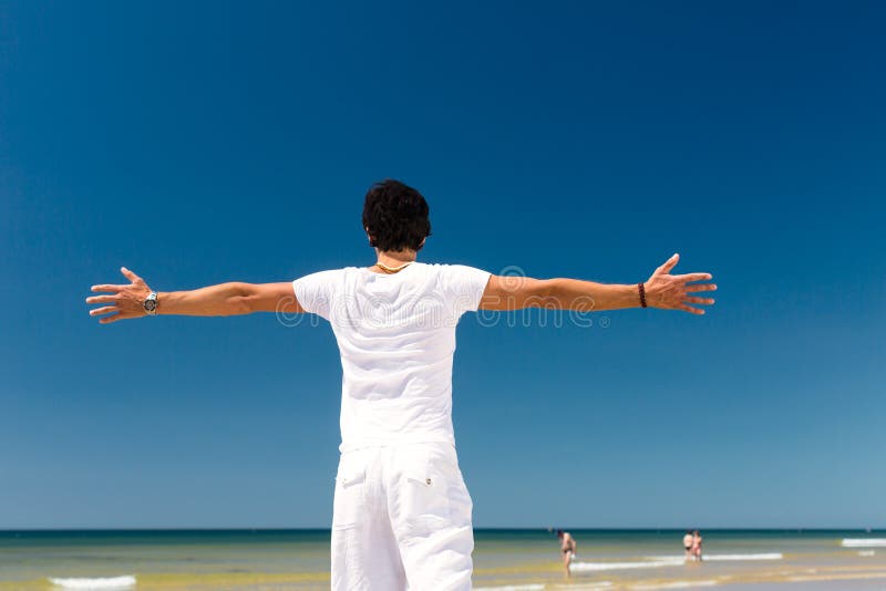 Handsome Man Standing in the Sun on Beach Stock Photo - Image of ...