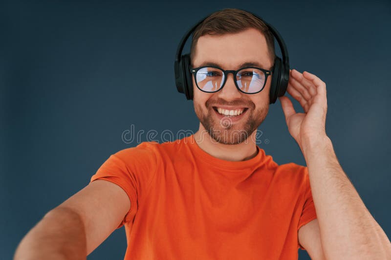 Handsome Man is in the Studio Against Blue Background Stock Image ...