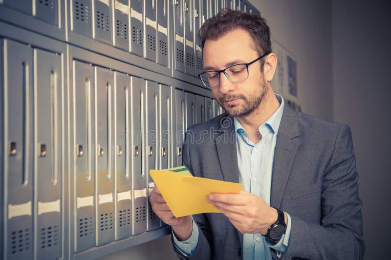 Handsome Man in Suit Checking Mail Next To the Mailboxes Stock Image ...