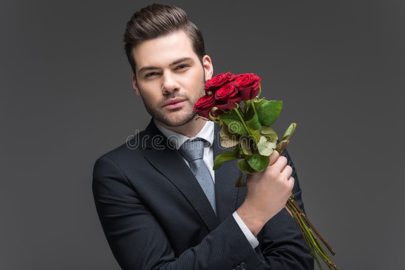 Handsome Man in Suit Holding Bouquet of Red Roses, Stock Photo - Image ...
