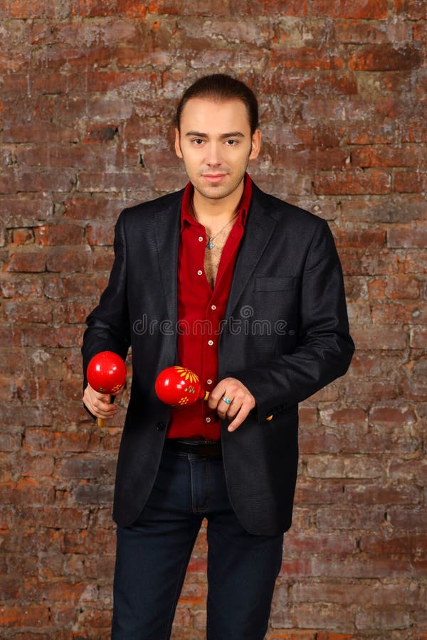 Handsome Man in Suit Stands with Red Maracas in Stock Image - Image of ...