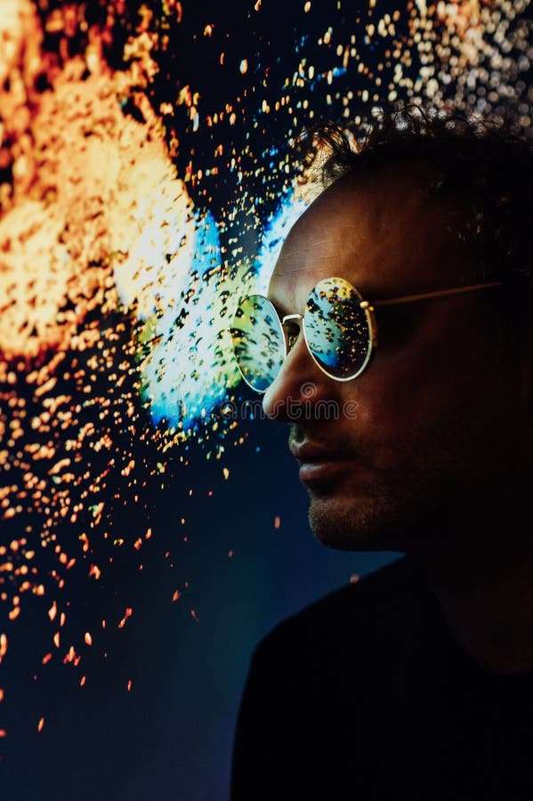 A Handsome Man in Sunglasses Next To Bright Led Lights Stock Photo ...