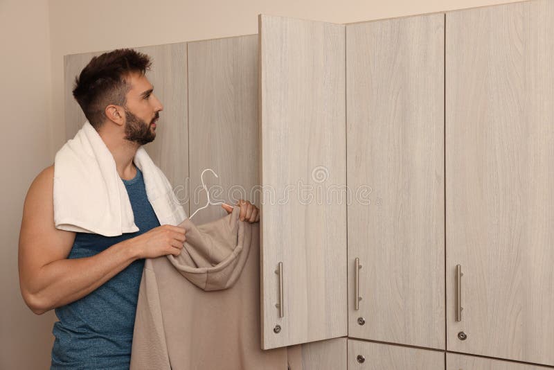 Handsome Man Taking Clothes from Locker in Changing Room Stock Photo ...