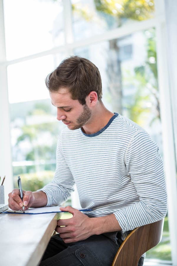 Handsome Man Taking Notes on Clipboard Stock Photo - Image of enjoying ...