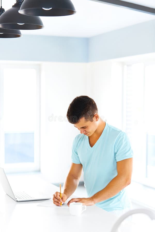 Handsome man taking notes. stock photo. Image of cheerful - 61072766