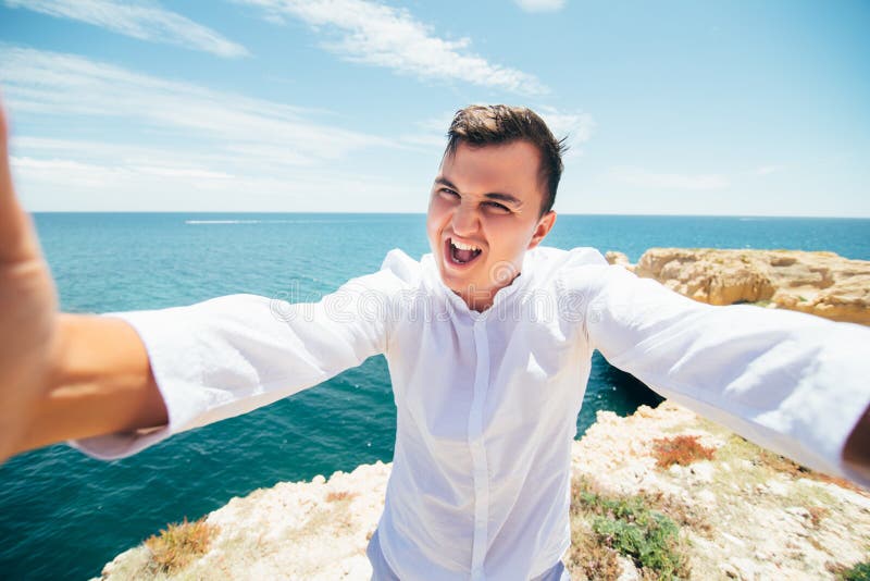 Handsome Young Man Taking A Selfie From Camera On Vacation On Ocean And