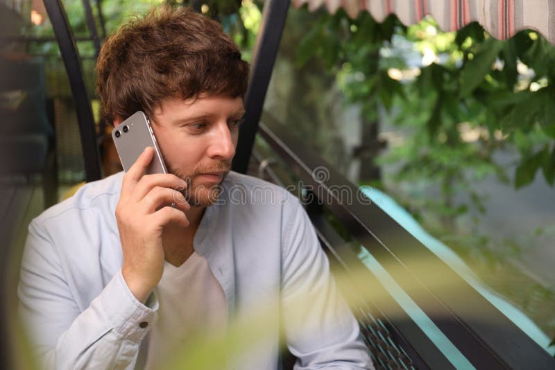 Handsome Man Talking on Phone in Outdoor Cafe Stock Image - Image of ...