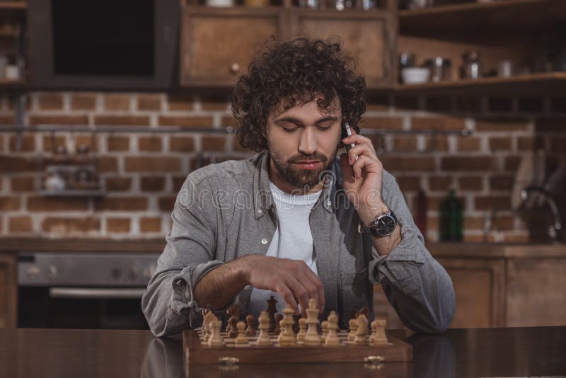 Handsome Man Talking by Smartphone and Playing Chess Stock Photo ...