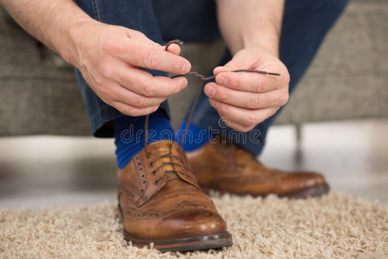 Handsome Man Tying Shoe Laces at Dressing Room Stock Photo - Image of ...