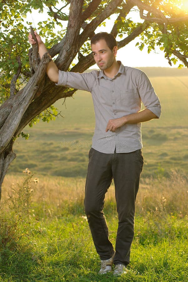 Handsome man under tree stock image. Image of herbs, stand - 33265945
