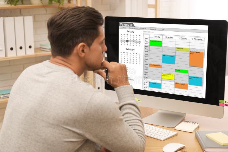 Handsome Man Using Calendar App on Computer Stock Photo - Image of ...