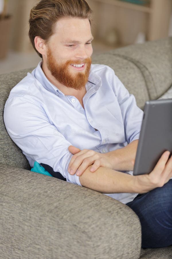 Handsome Man Using Digital Tablet and Smiling Stock Photo - Image of ...