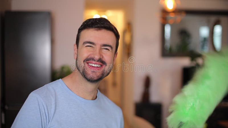 Handsome Man Using a Feather Duster Stock Footage - Video of dusty ...