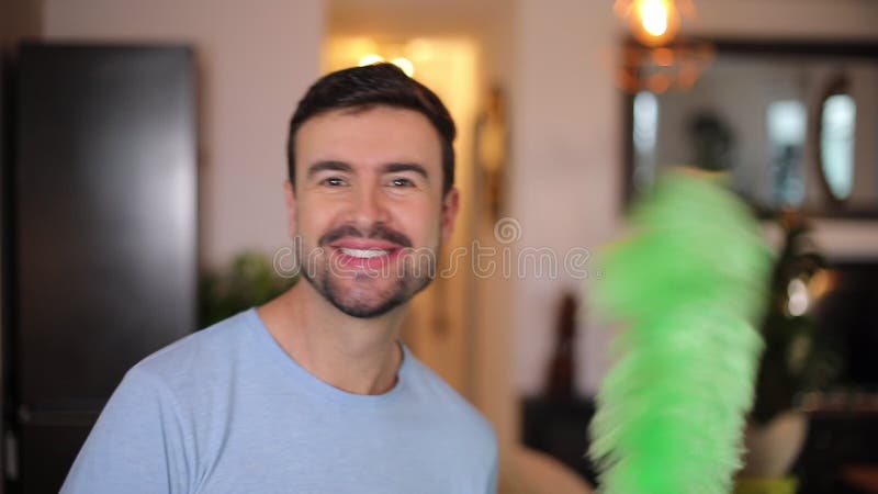 Handsome Man Using a Feather Duster Stock Footage - Video of broom ...