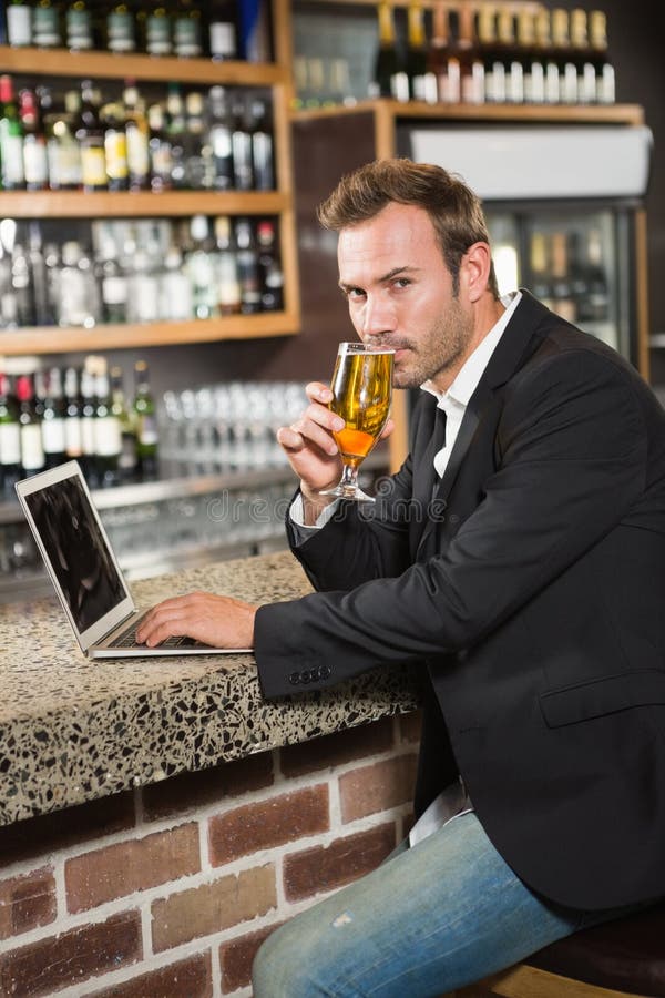 Handsome Man Using Laptop Computer and Drinking a Beer Stock Photo ...
