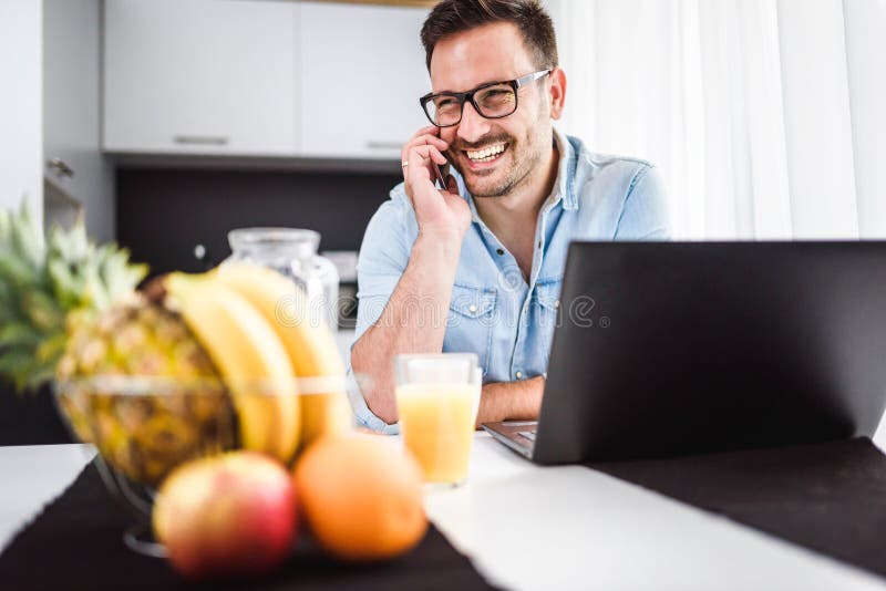 Handsome Man Using Laptop Computer at Home, Drinking Juice and Coffee ...