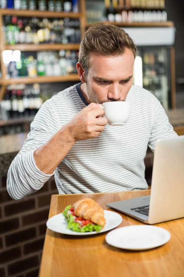 Handsome Man Using Laptop and Having a Coffee Stock Image - Image of ...