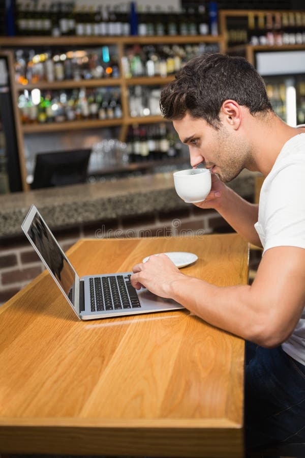 Handsome Man Using Laptop and Having Coffee Stock Photo - Image of ...