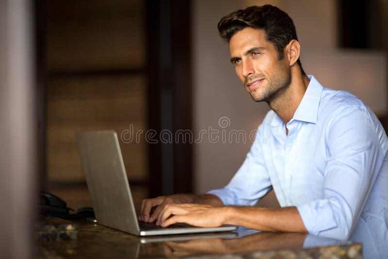 Handsome man using laptop stock photo. Image of laptop - 65785164