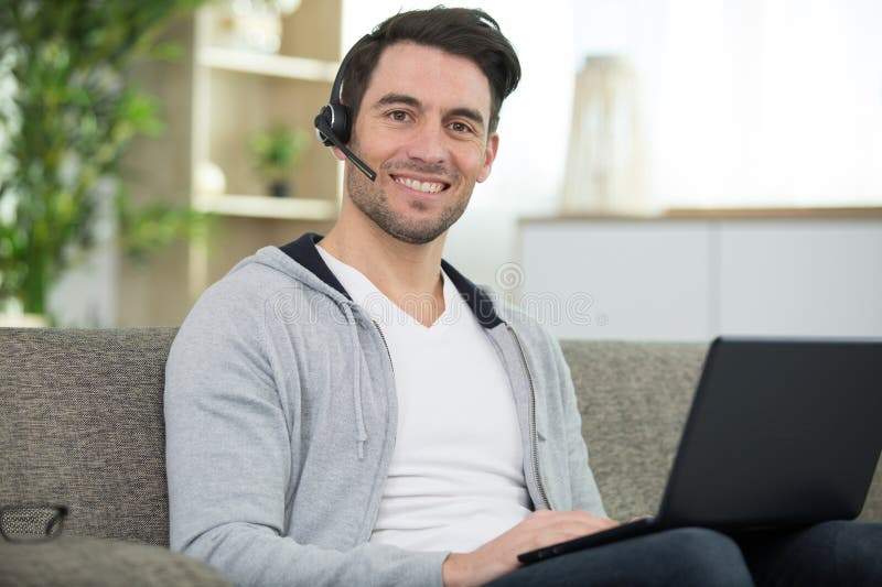 Handsome Man Using Laptop while Sitting on Couch Stock Photo - Image of ...