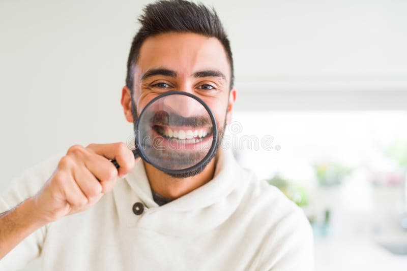 Handsome Man Using Magnifying Glass, Doing Funny Faces Stock Photo ...