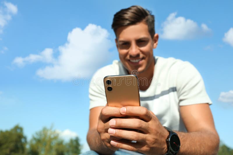 Handsome Man Using Modern Mobile Phone Outdoors, Focus on Hand Stock ...