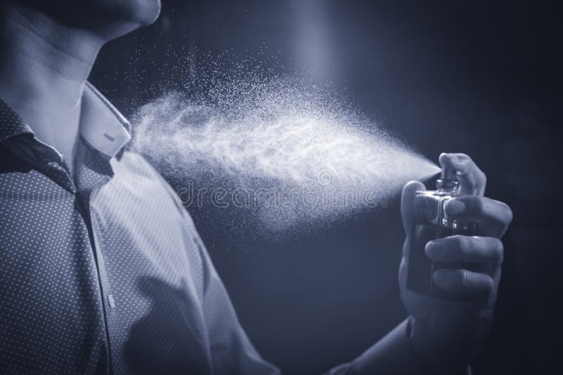 Handsome man using perfume stock photo. Image of background - 105324286