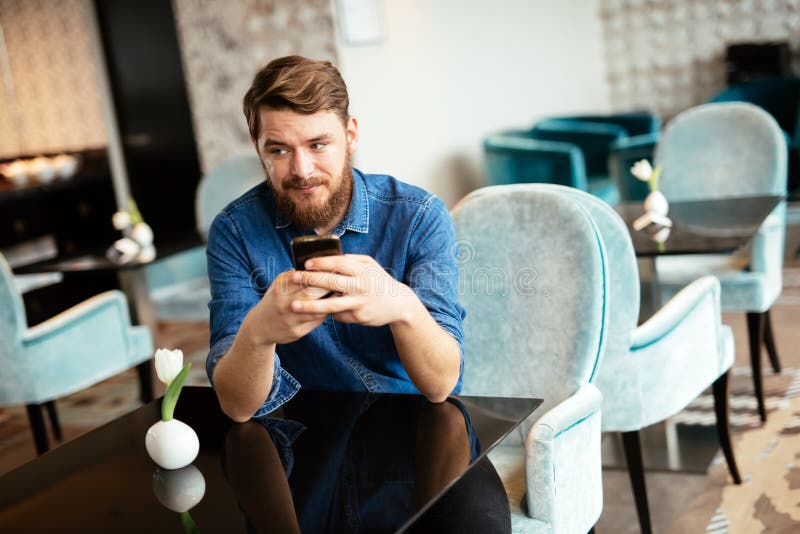 Handsome Man Using Phone in Restaurant Stock Image - Image of ...