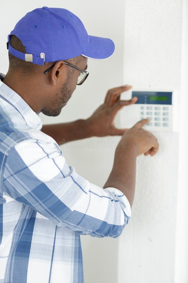 Handsome Man Using Security Alarm System Indoors Stock Image - Image of ...