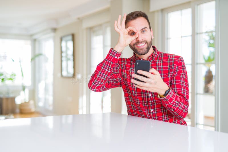 Handsome Man Using Smartphone with Happy Face Smiling Doing Ok Sign ...