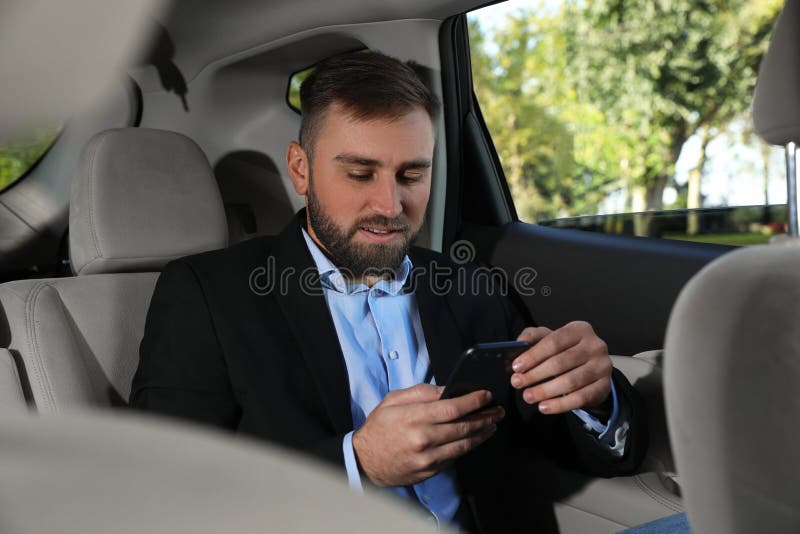 Handsome Man Using Smartphone in Modern Car Stock Image - Image of ...