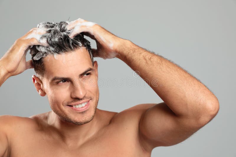 Handsome Man Washing Hair on Grey Background Stock Photo - Image of ...