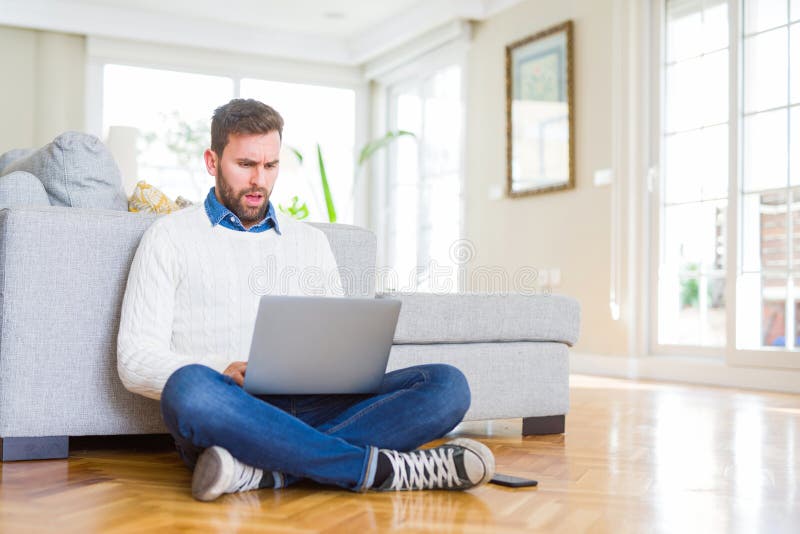 Handsome Man Wearing Working Using Computer Laptop Scared in Shock with ...