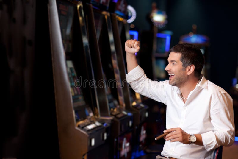Handsome Man Winning at the Slot Machine Stock Photo - Image of ...