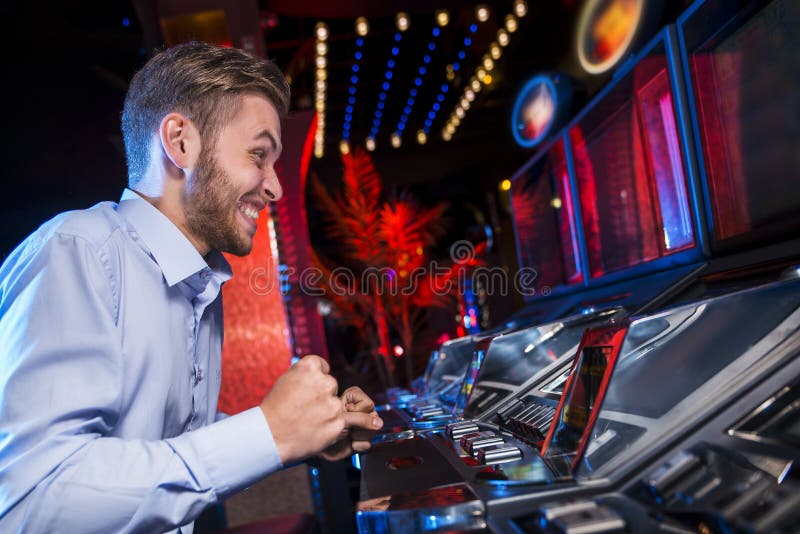 Handsome Man Winning at the Slot Machine Stock Image - Image of excited ...
